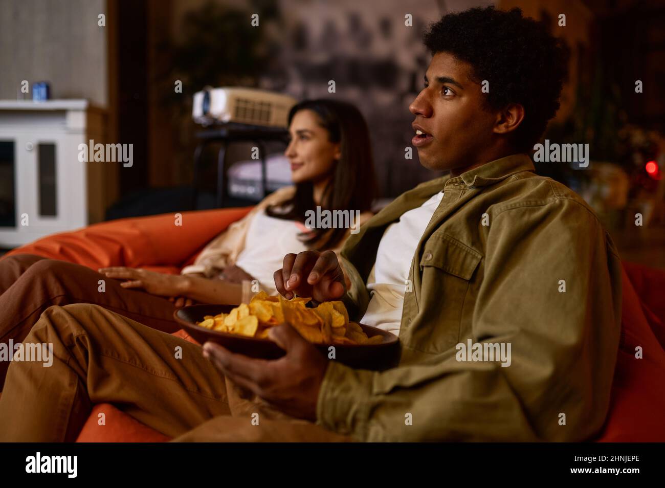 Young family watching movie together hi-res stock photography and ...