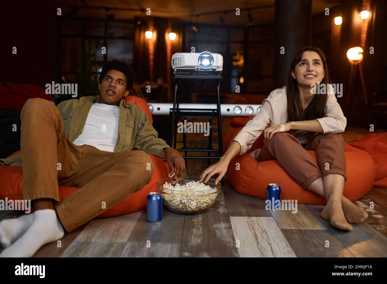 Couple eating popcorn enjoy watching exciting movie Stock Photo - Alamy