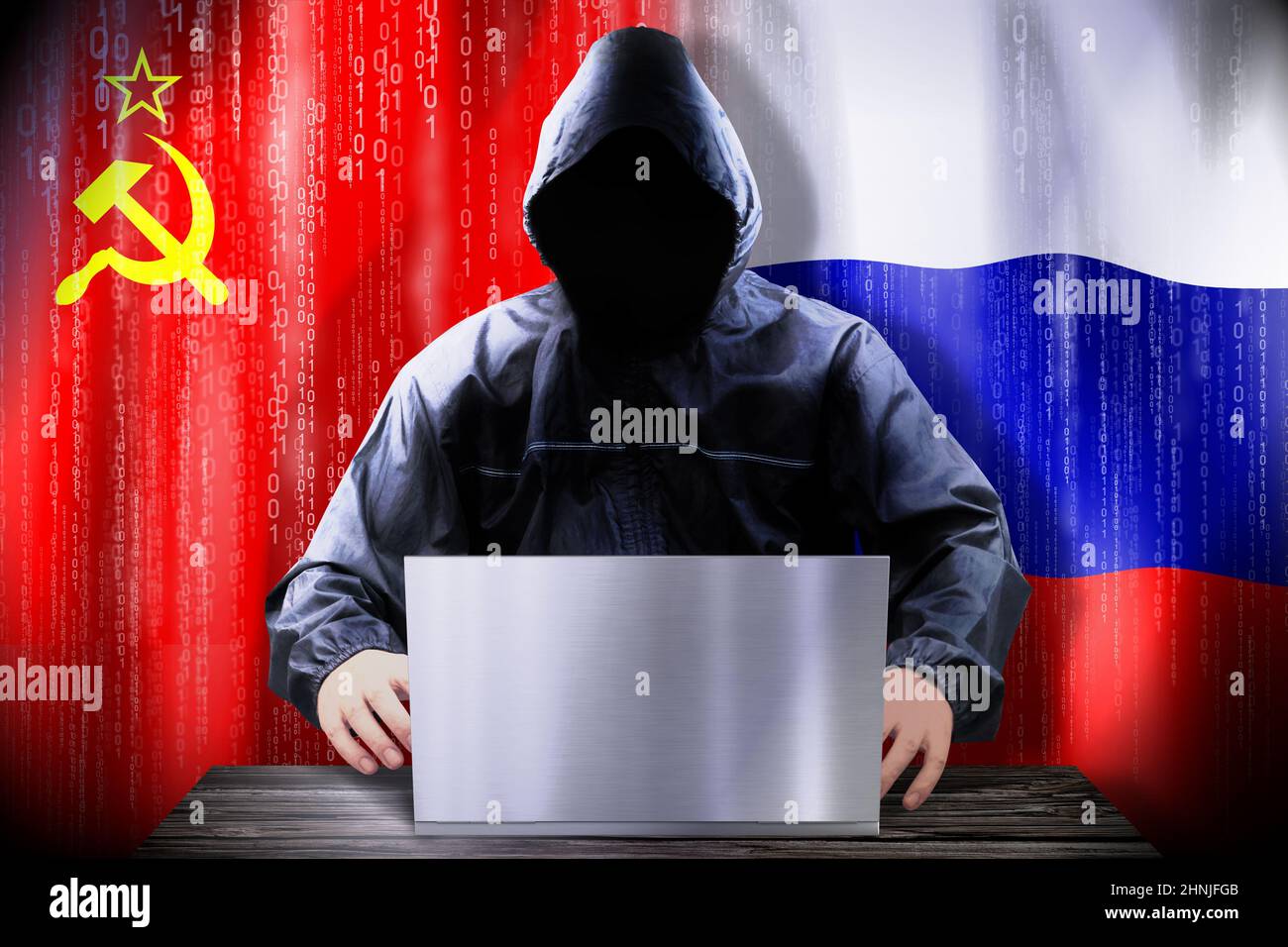 Anonymous hacker working on a laptop, flags of CCCP and Russian ...