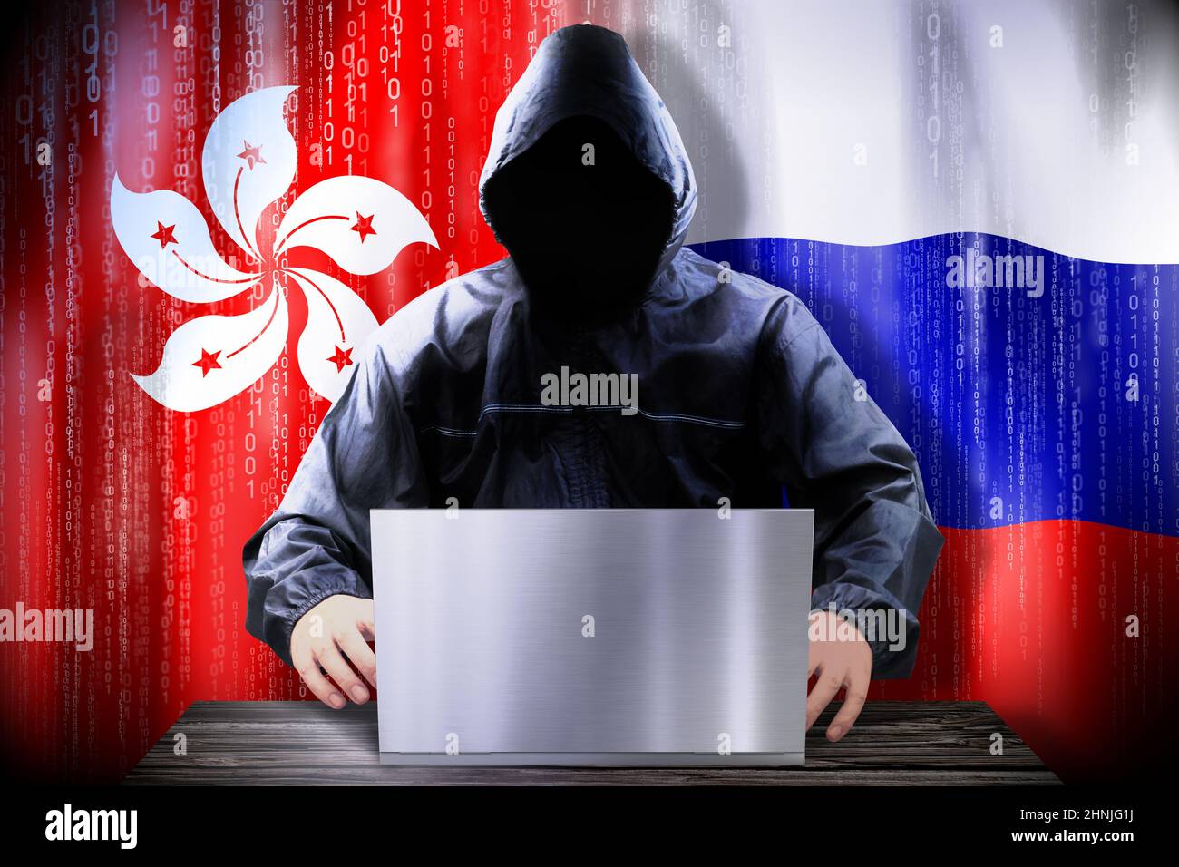 Anonymous hacker working on a laptop, flags of Hong Kong and Russia ...