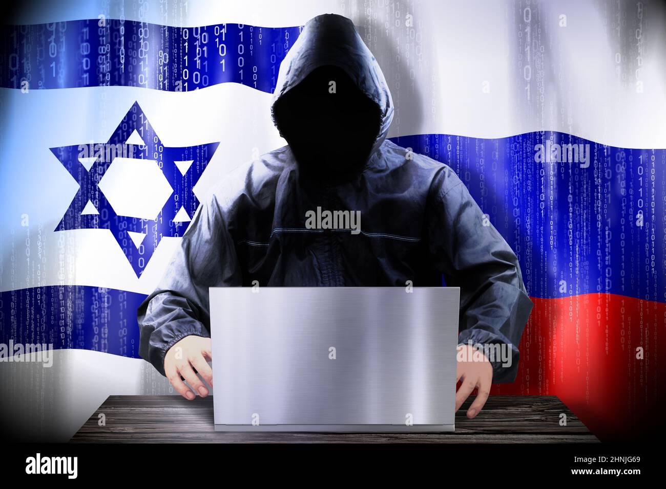 Anonymous hacker working on a laptop, flags of Israel and Russia Stock ...