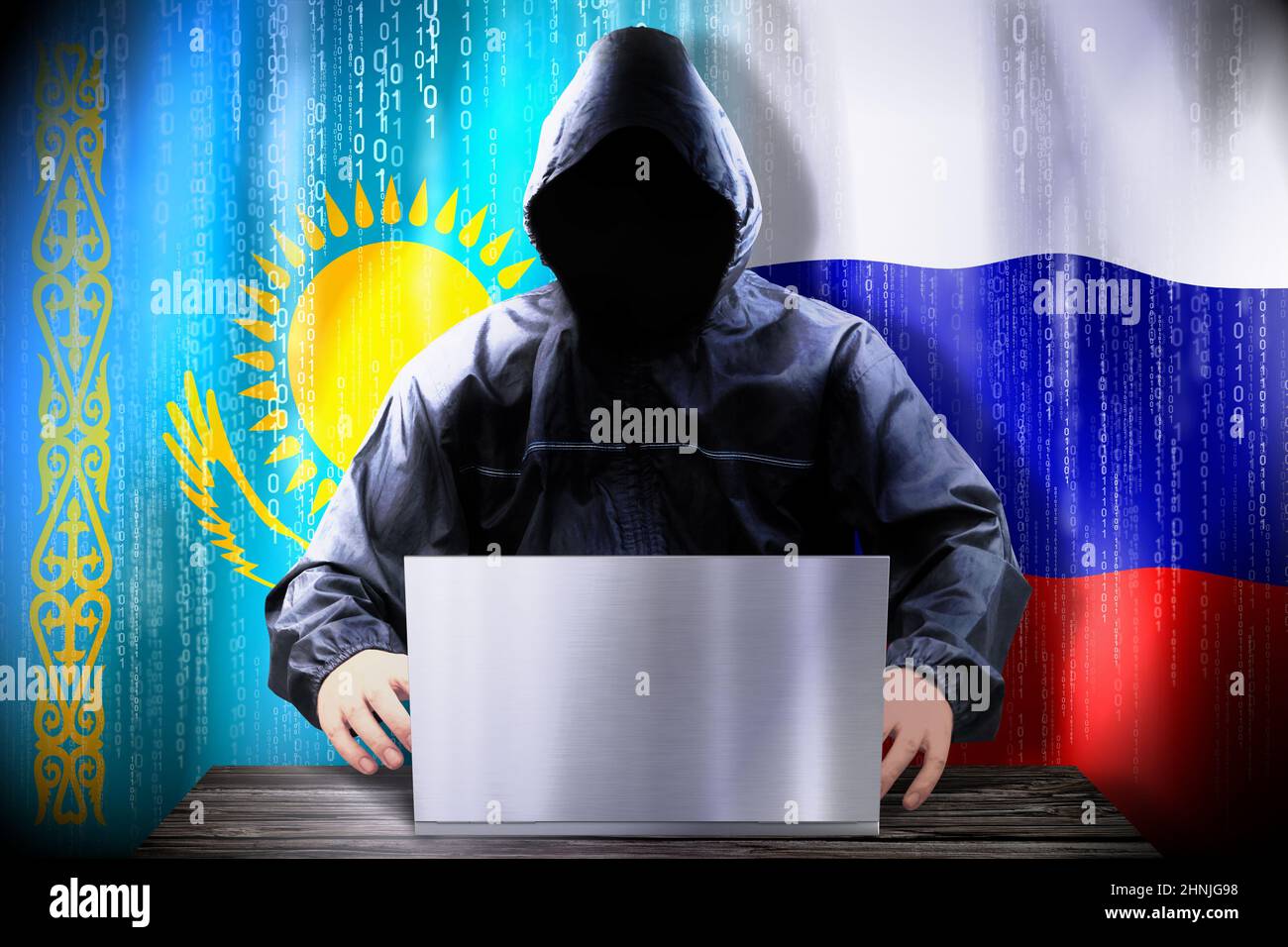 Anonymous hacker working on a laptop, flags of Kazakhstan and Russia ...