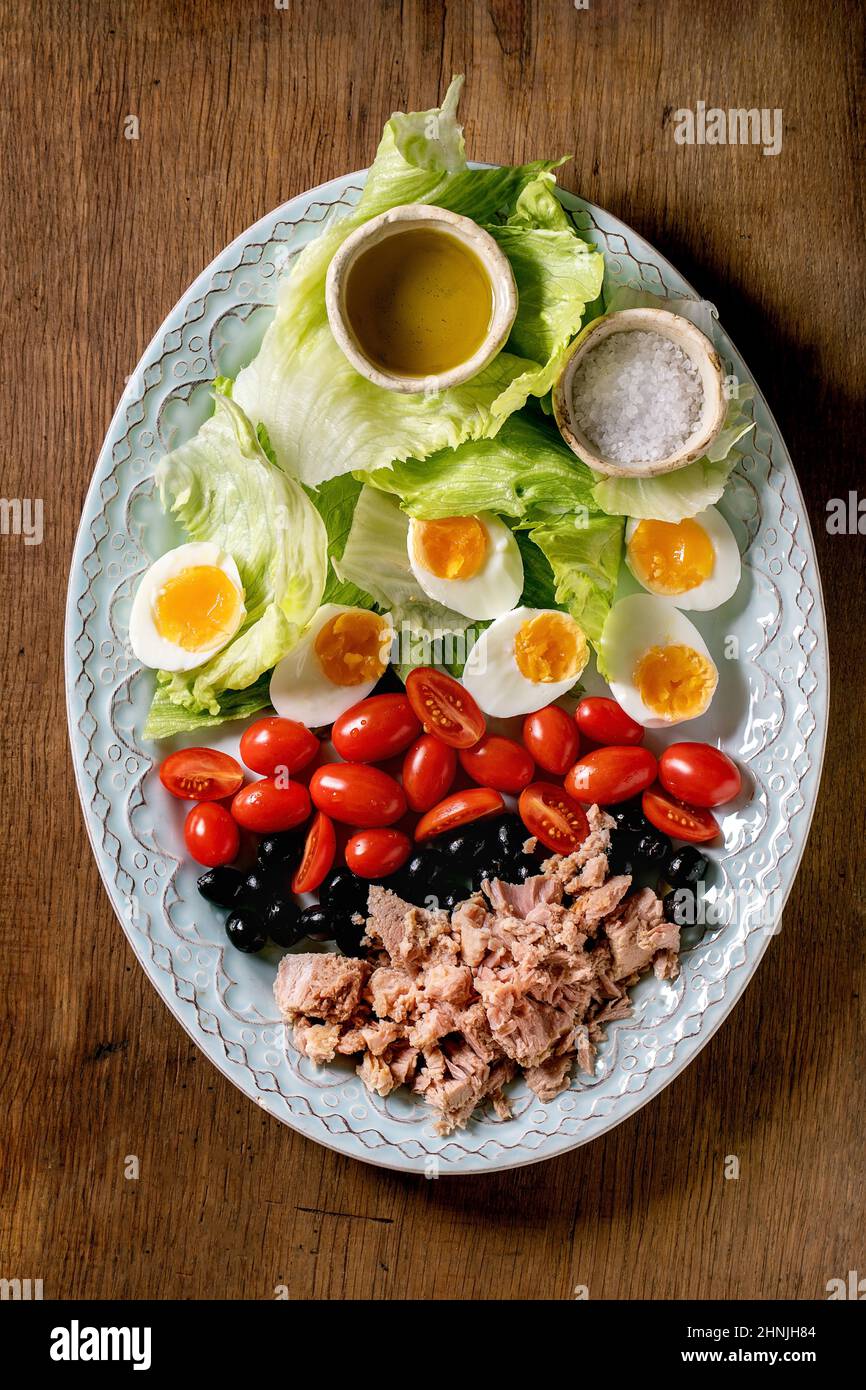 Layered Traditional nicoise salad with canned tuna fish, olives and ...