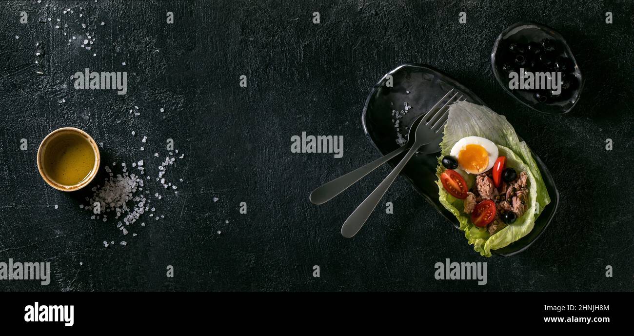 Traditional nicoise salad with canned tuna fish, olives and eggs ...