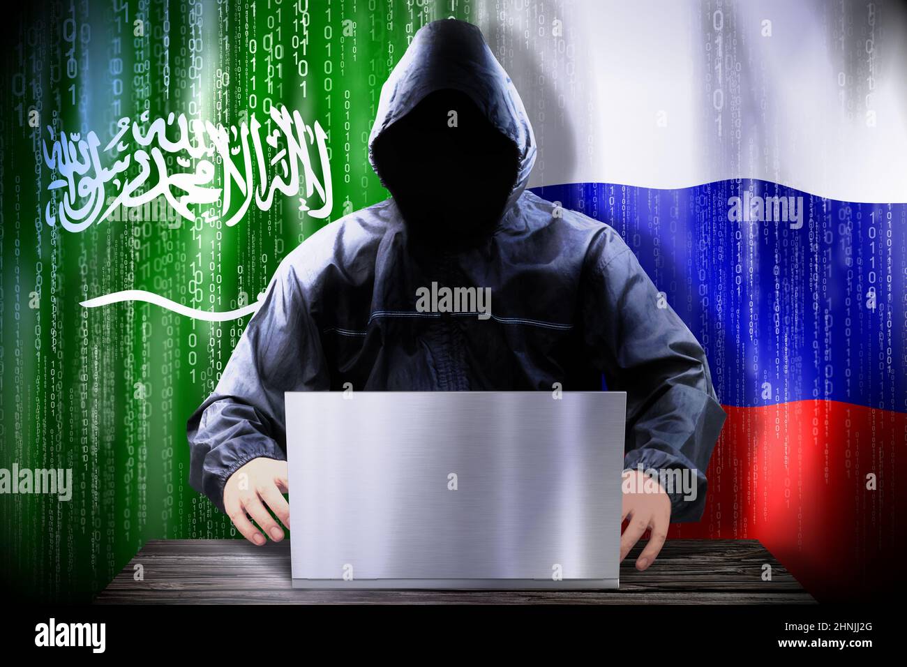 Anonymous hacker working on a laptop, flags of Saudi Arabia and Russia ...