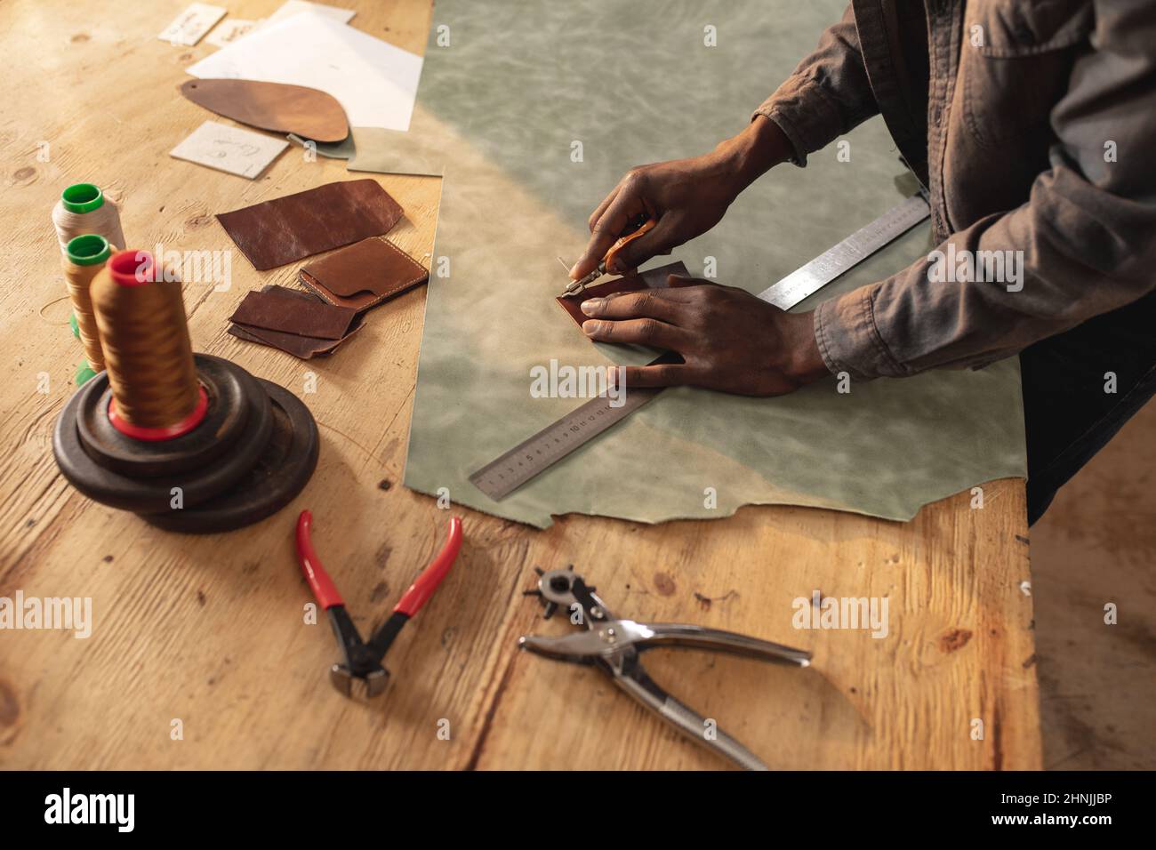 African american craftsman working leather hi-res stock photography and ...