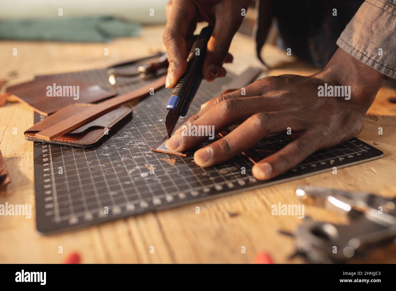 African american craftsman working leather hi-res stock photography and ...