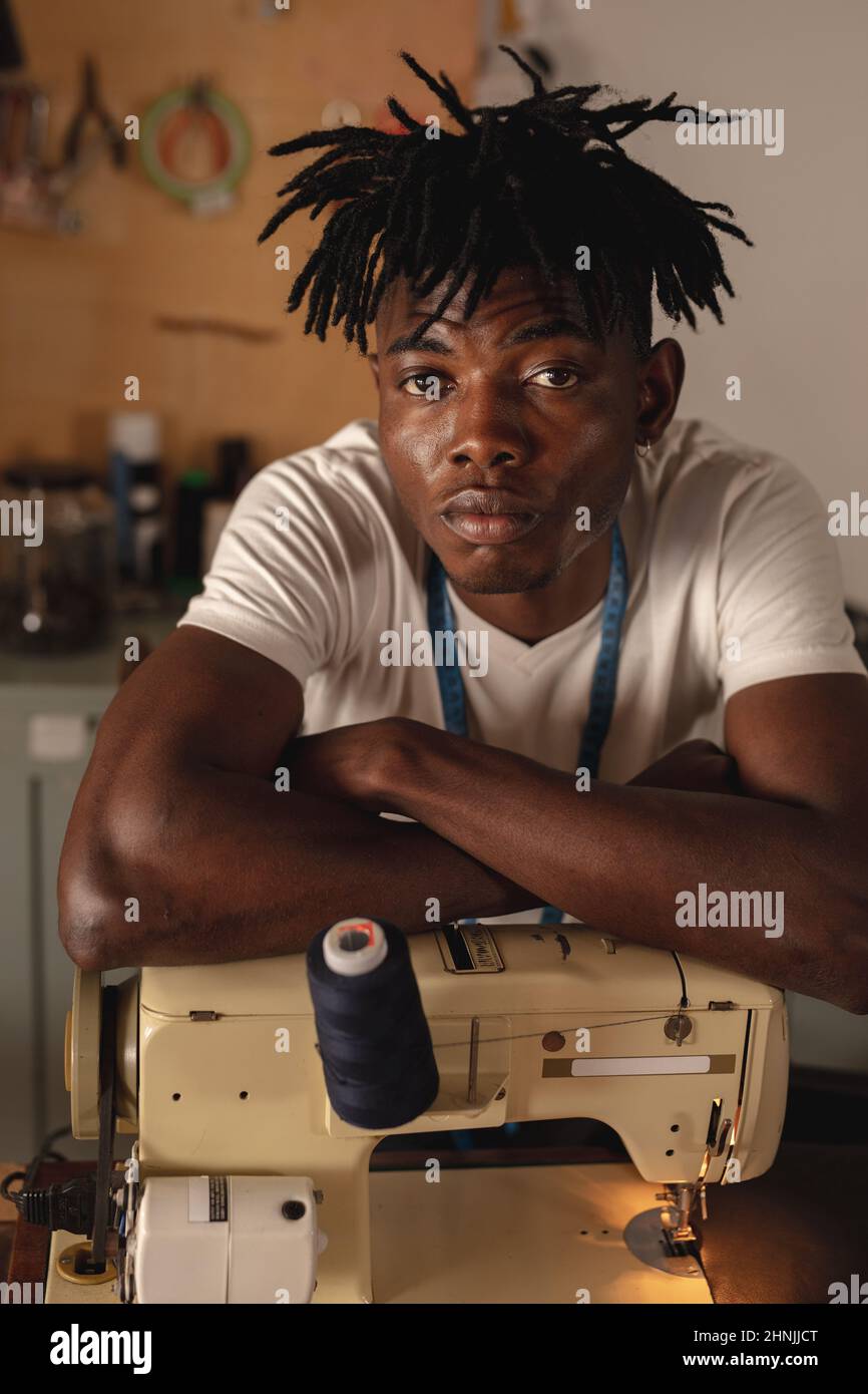 Close-up portrait of african american young craftsman with arms crossed ...