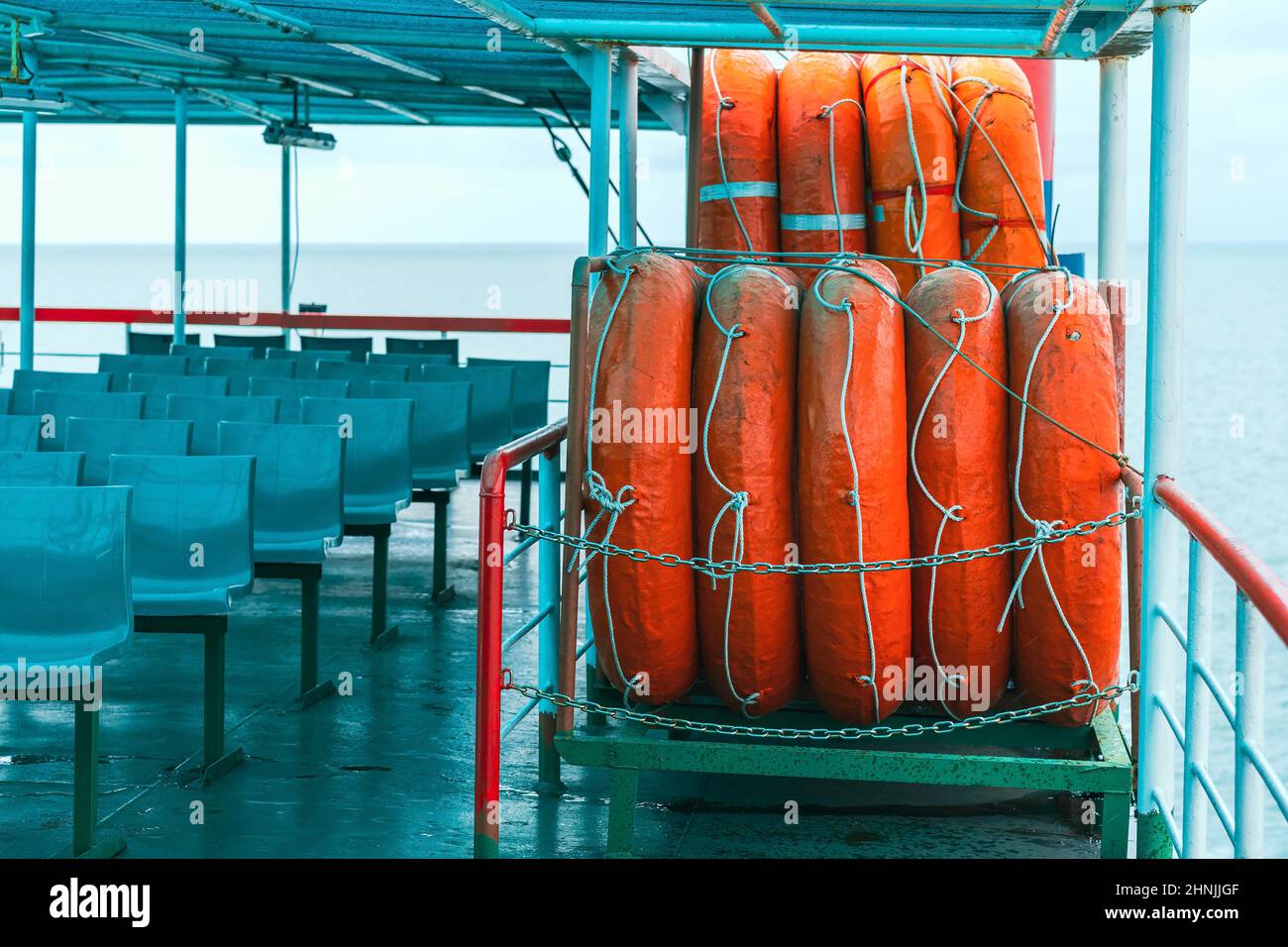 Orange inflatable lifeboats on ferry deck for emergencies and maritime ...