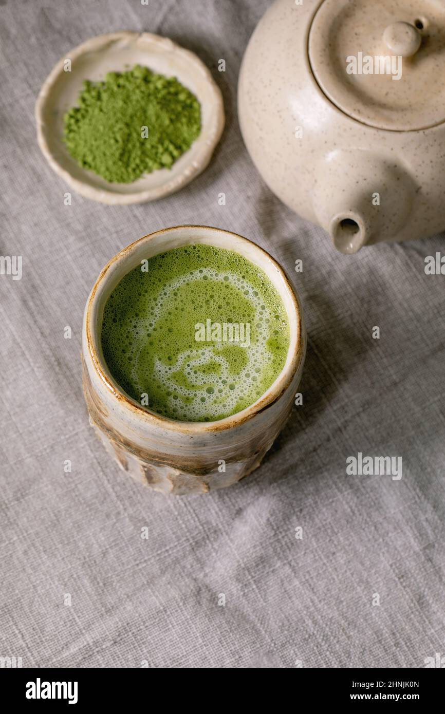 Traditional japanese hot green frothy tea matcha latte in handmade ...