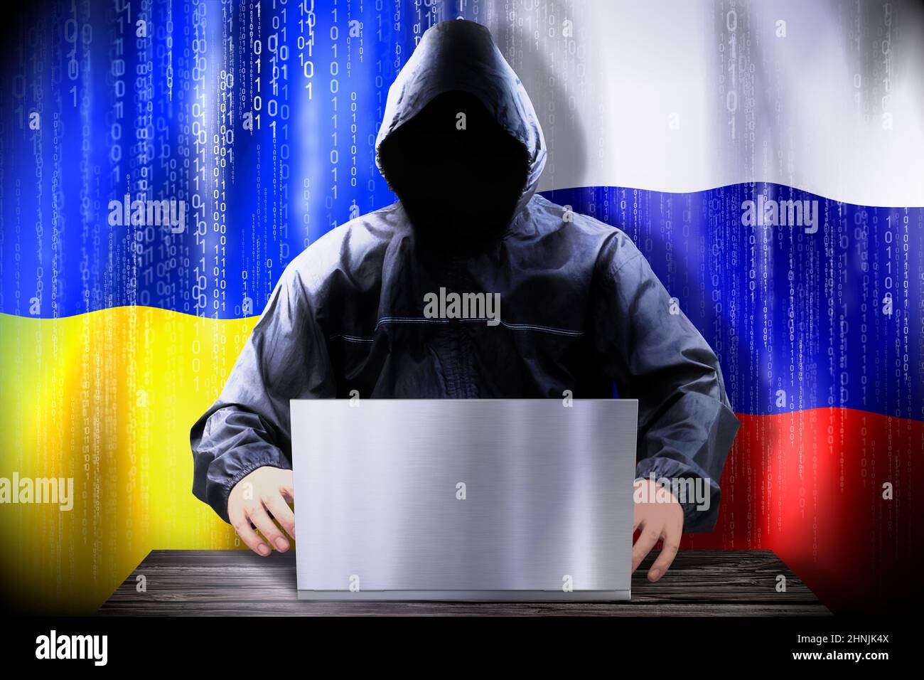 Anonymous hacker working on a laptop, flags of Ukraine and Russia Stock ...