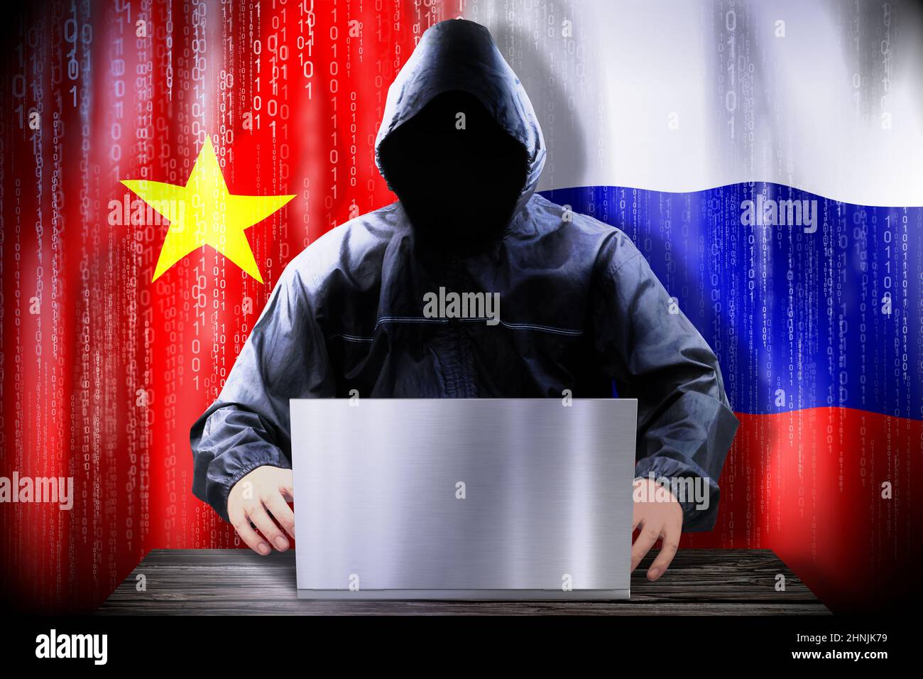 Anonymous hacker working on a laptop, flags of Vietnam and Russia Stock Photo - Alamy
