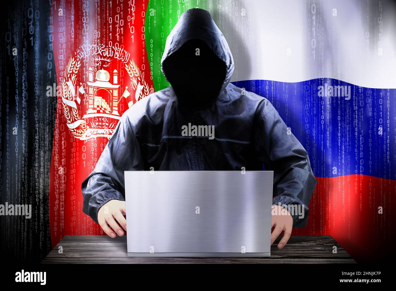 Anonymous hacker working on a laptop, flags of Afghanistan and Russia ...