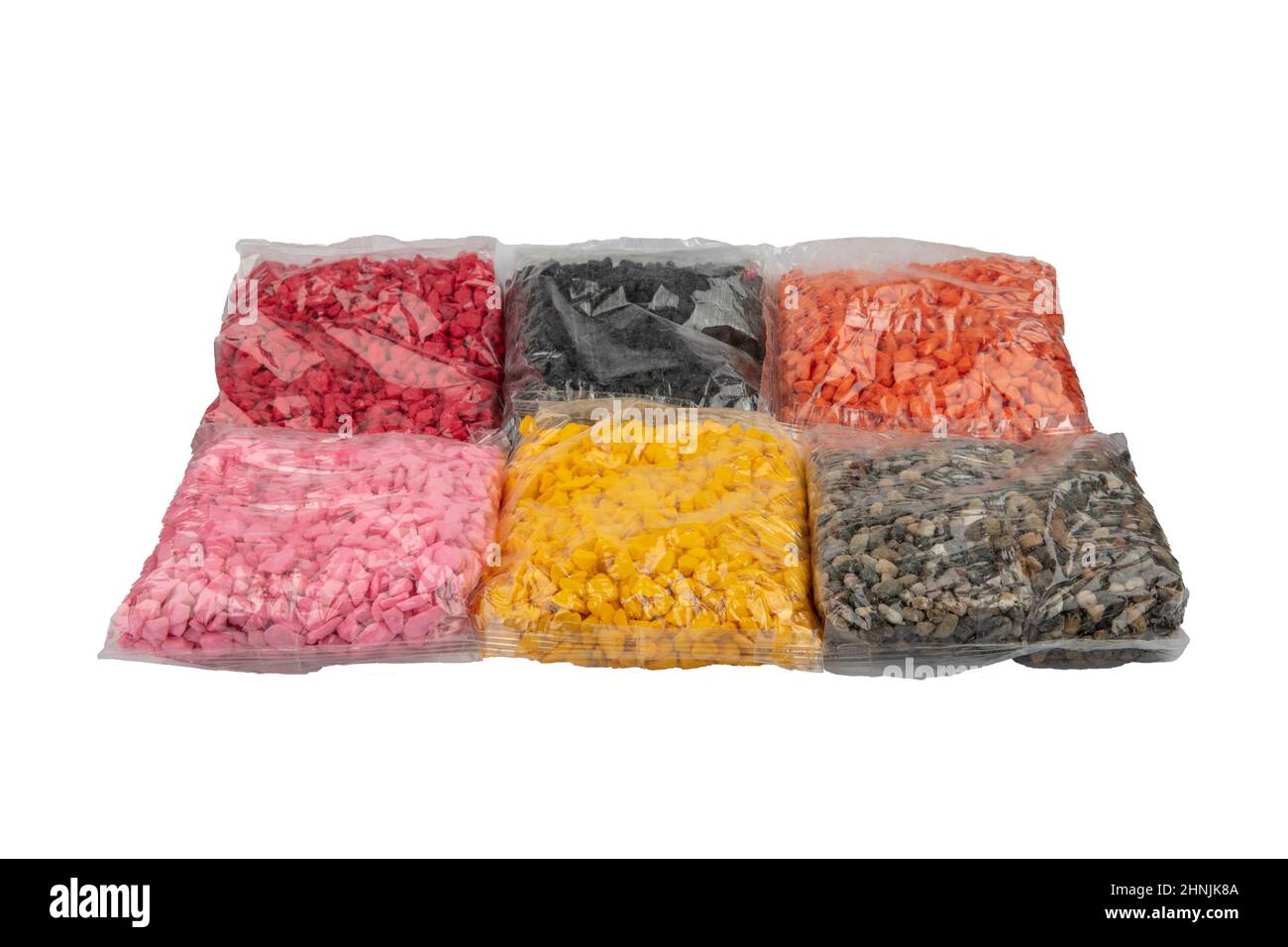 Colorful pebbles in plastic bags for decoration work in craft shop ...