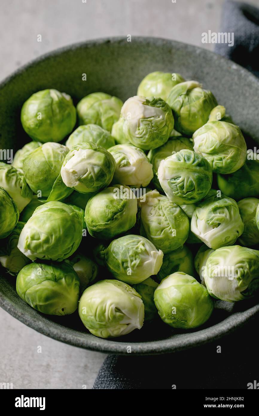 Heap of peeled raw organic brussels sprouts mini cabbage in ceramic ...