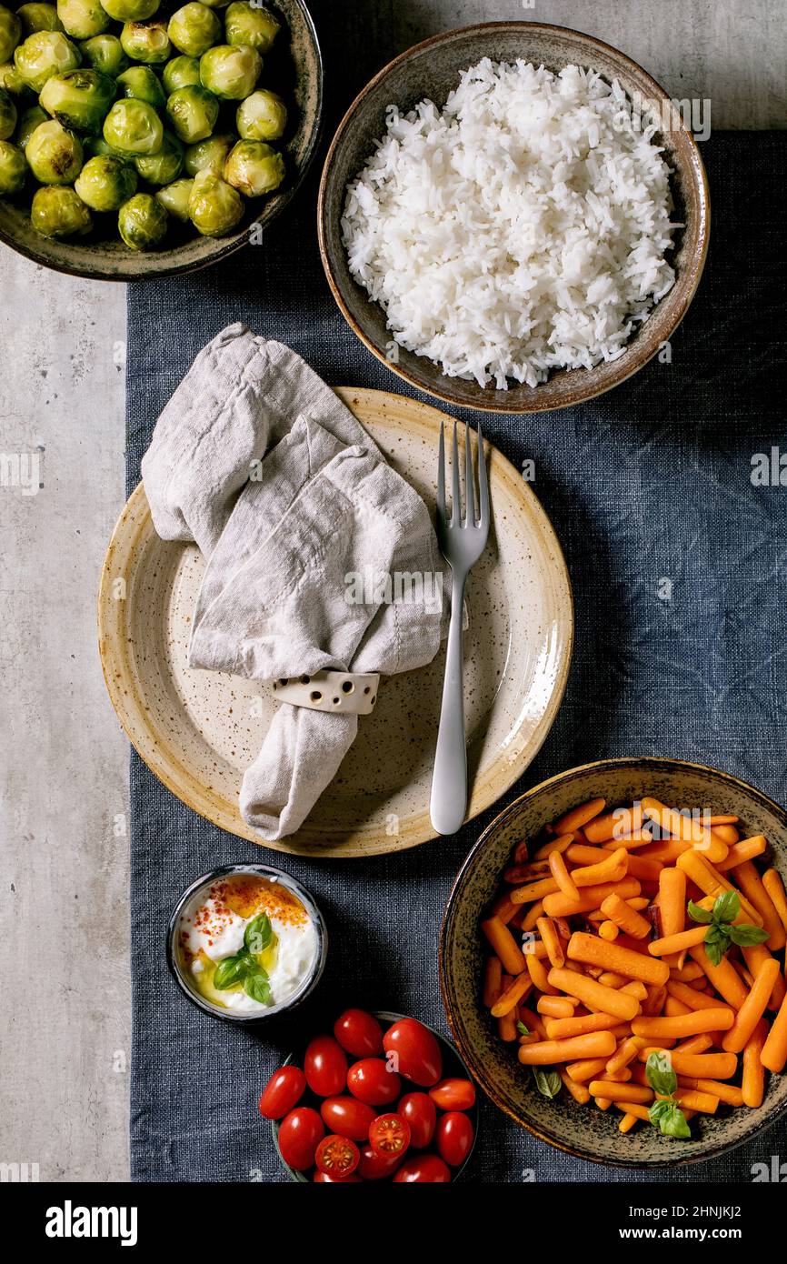 Vegan dinner table with rice and vegetables baked brussel sprouts, baby ...