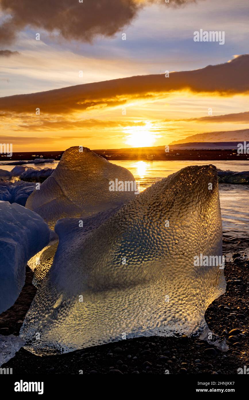 sun shining through ice at Diamond Beach, Breidamerkursandur, southeast ...