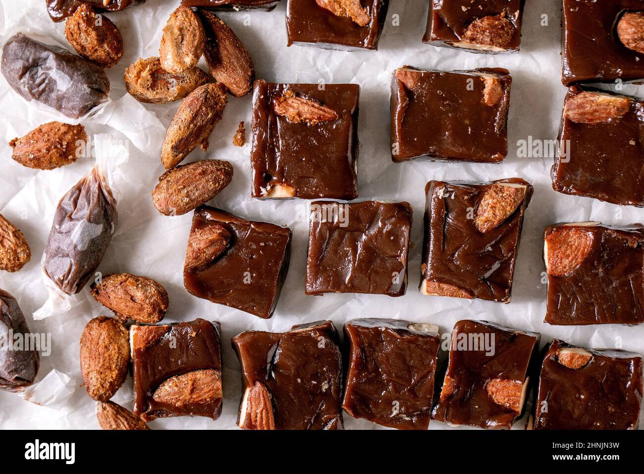 Homemade toffee salted caramel chocolate almond nuts candy on crumpled ...