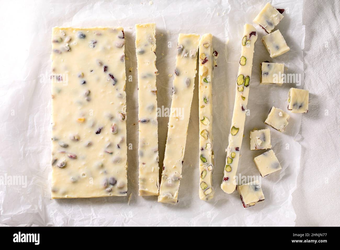 Sliced strips and squares homemade white chocolate candy bar with ...
