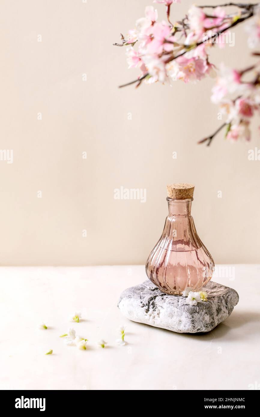 Glass pink transparent bottle of perfume with cork, standing on ...