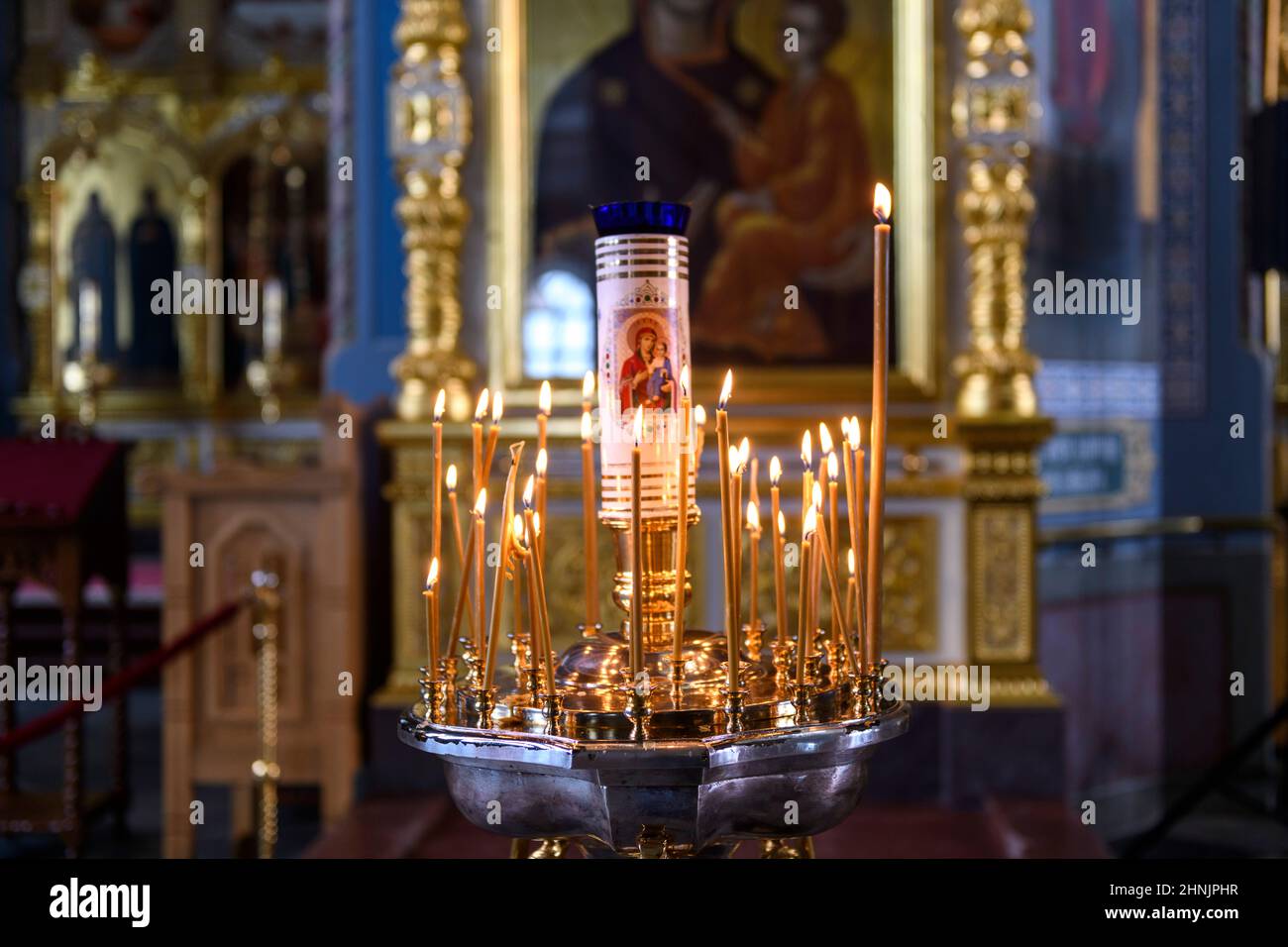 Church candles on the background of icons in Russian orthodox cathedral ...