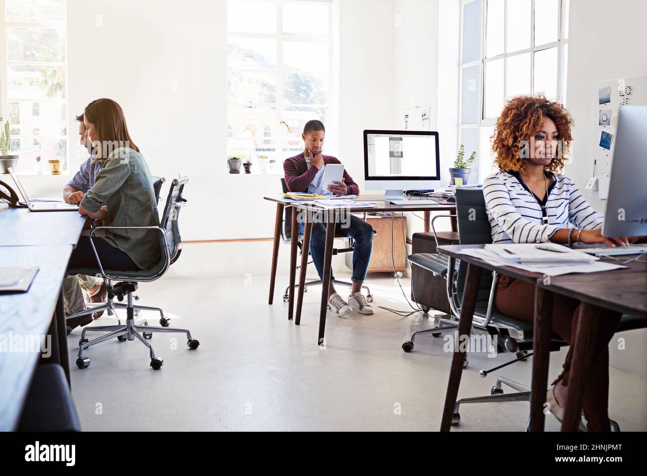 Working individually but as a team. Shot of colleagues working on their ...