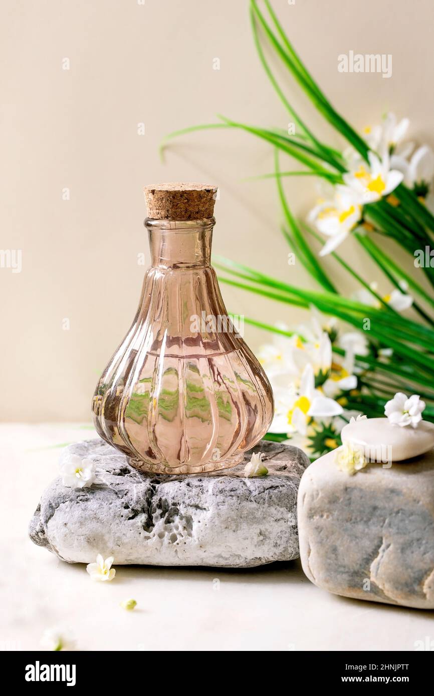 Beautiful pink transparent bottle of perfume with cork, standing on ...