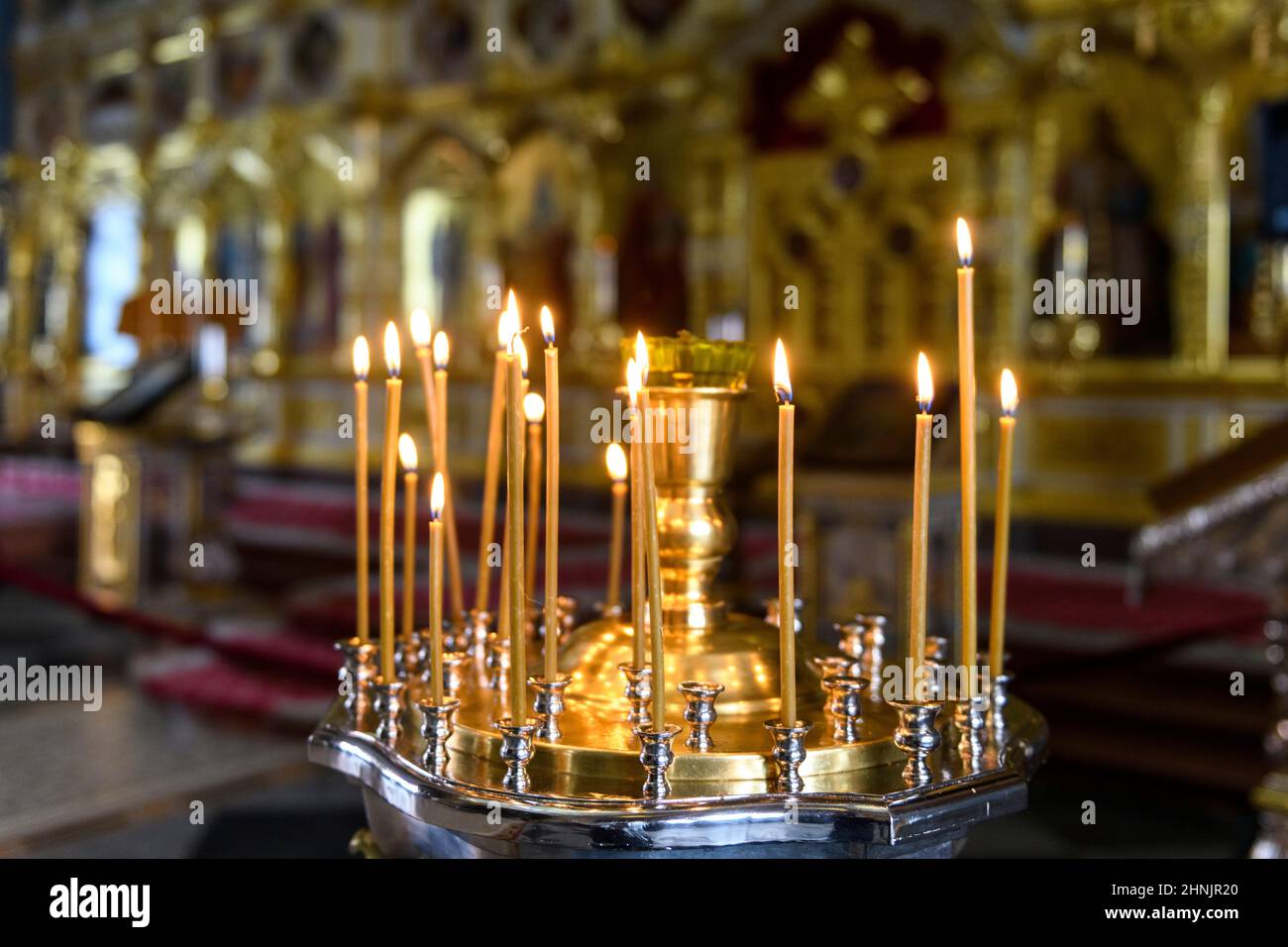 Church candles on the background of icons in Russian orthodox cathedral ...