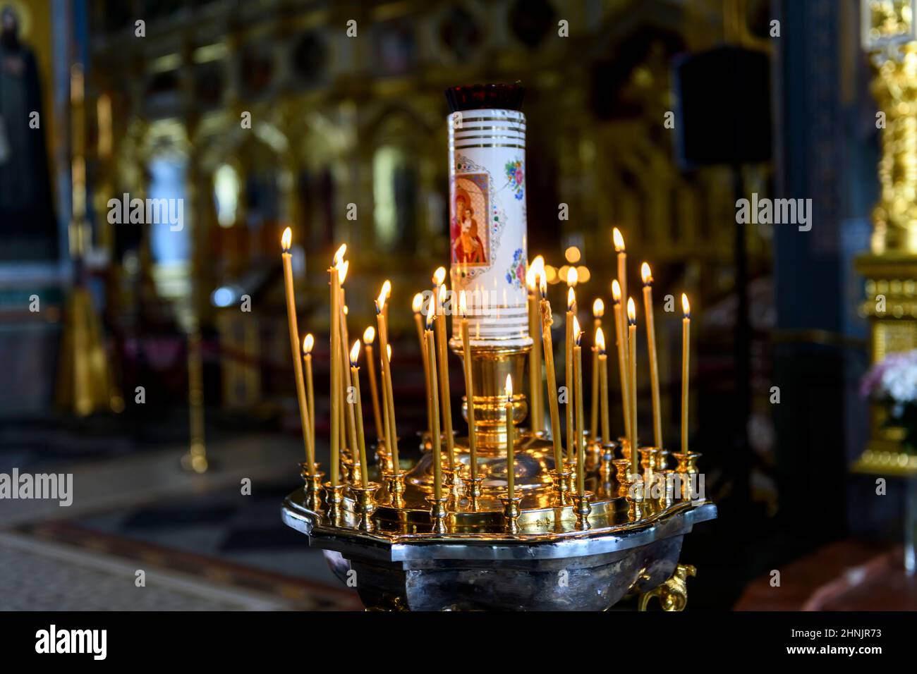 Church candles on the background of icons in Russian orthodox cathedral ...
