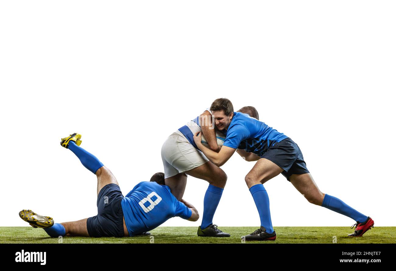 Dynamic portrait of male rugby players playing rugby football on grass ...