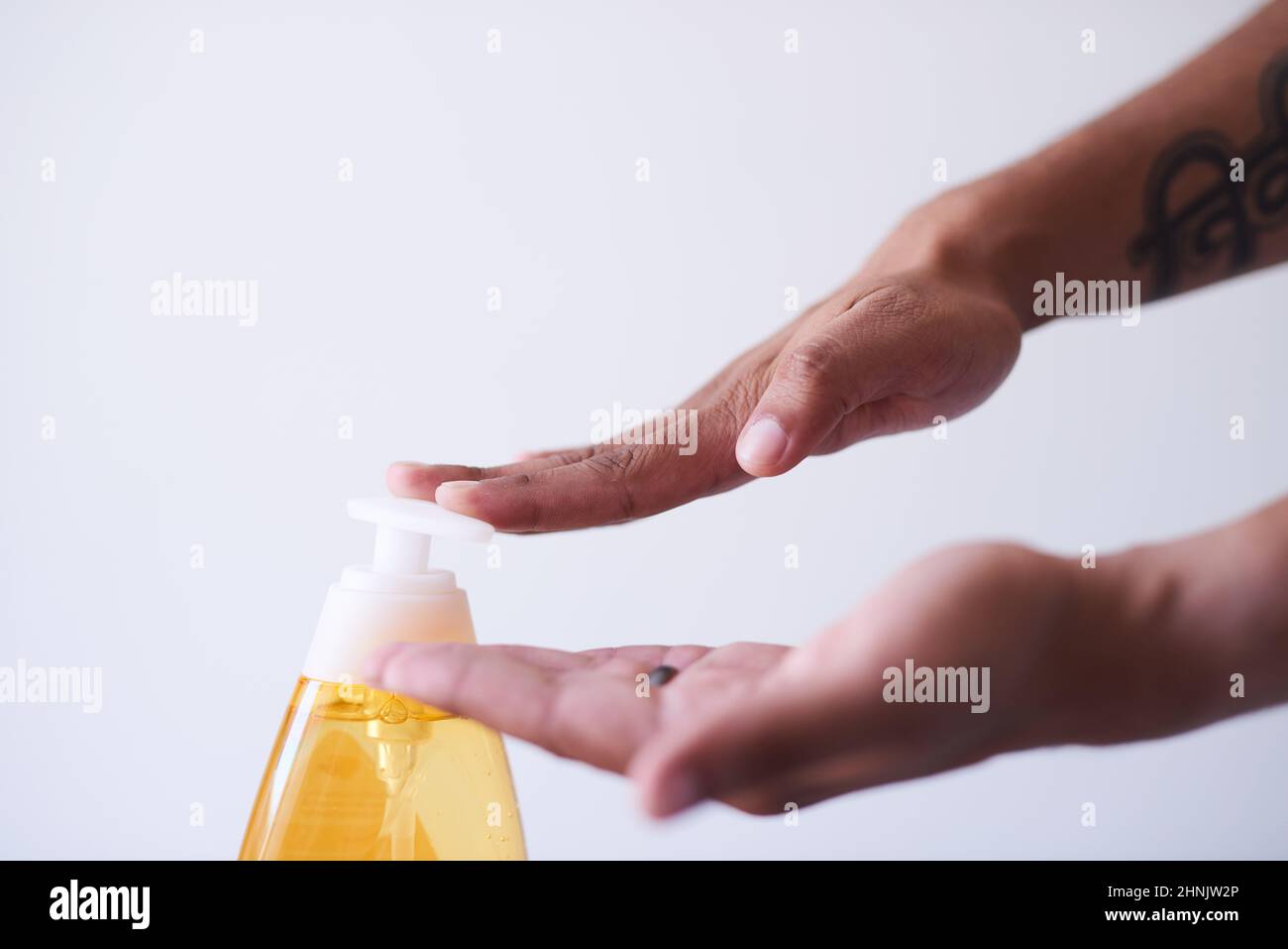 A close up shot of hands dispensing soap with a white background Stock ...