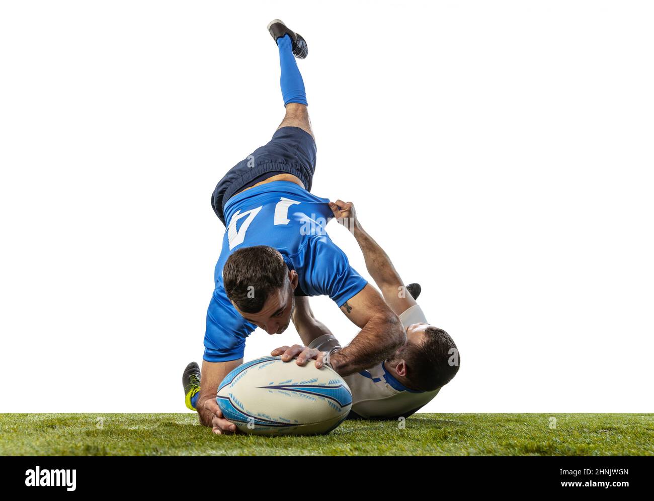 Dynamic portrait of male rugby players playing rugby football on grass ...