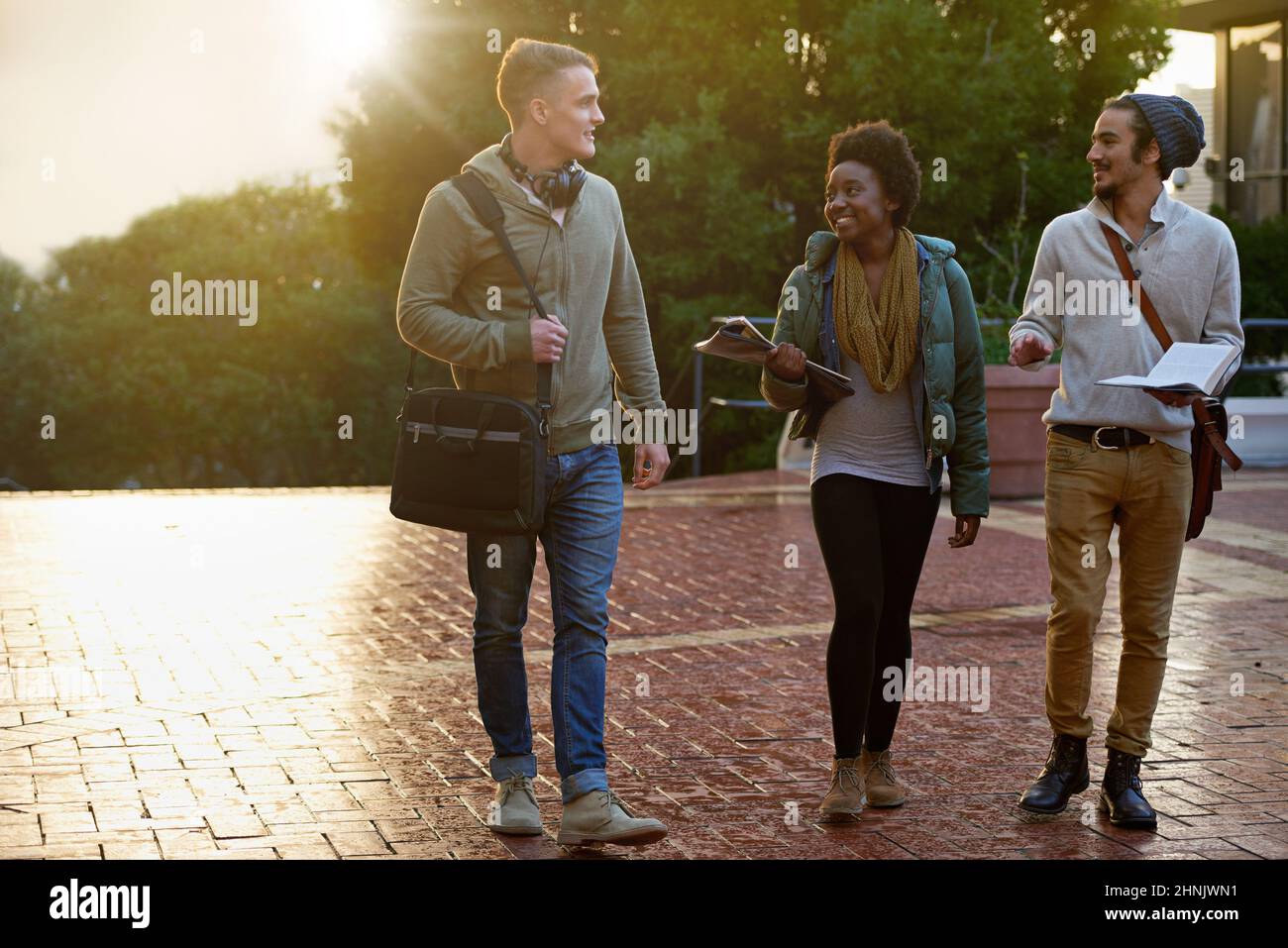 Headed into college for the day. Full length shot of three college ...