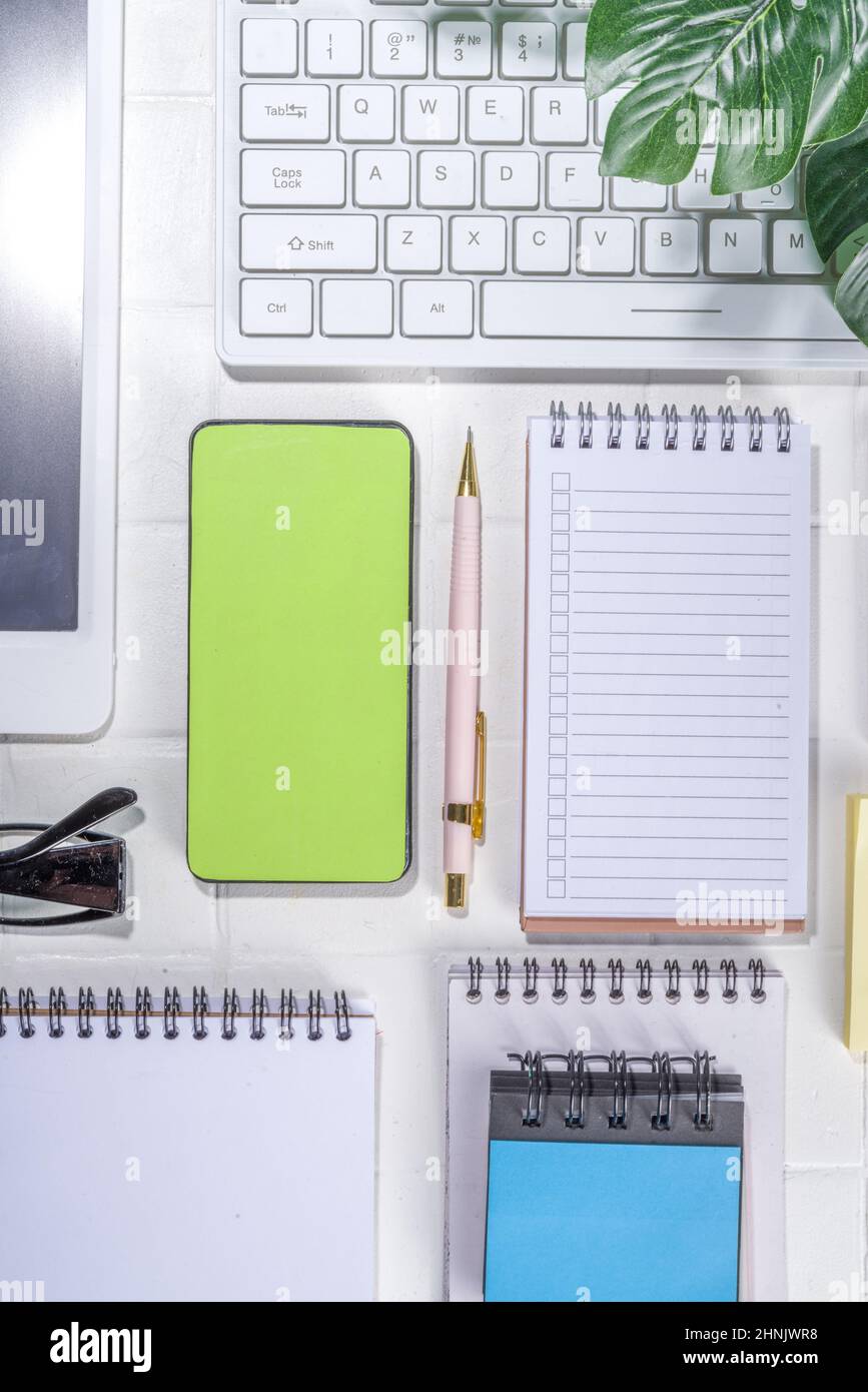 Office desk background. Laptop keyboard, smartphone and various work ...