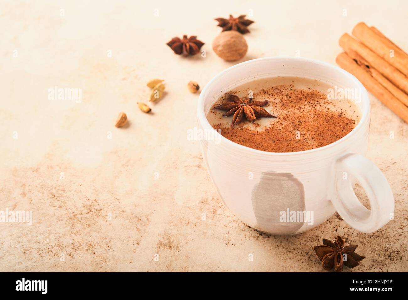 Masala tea. Masala chai spiced tea with milk and spices on light warm ...