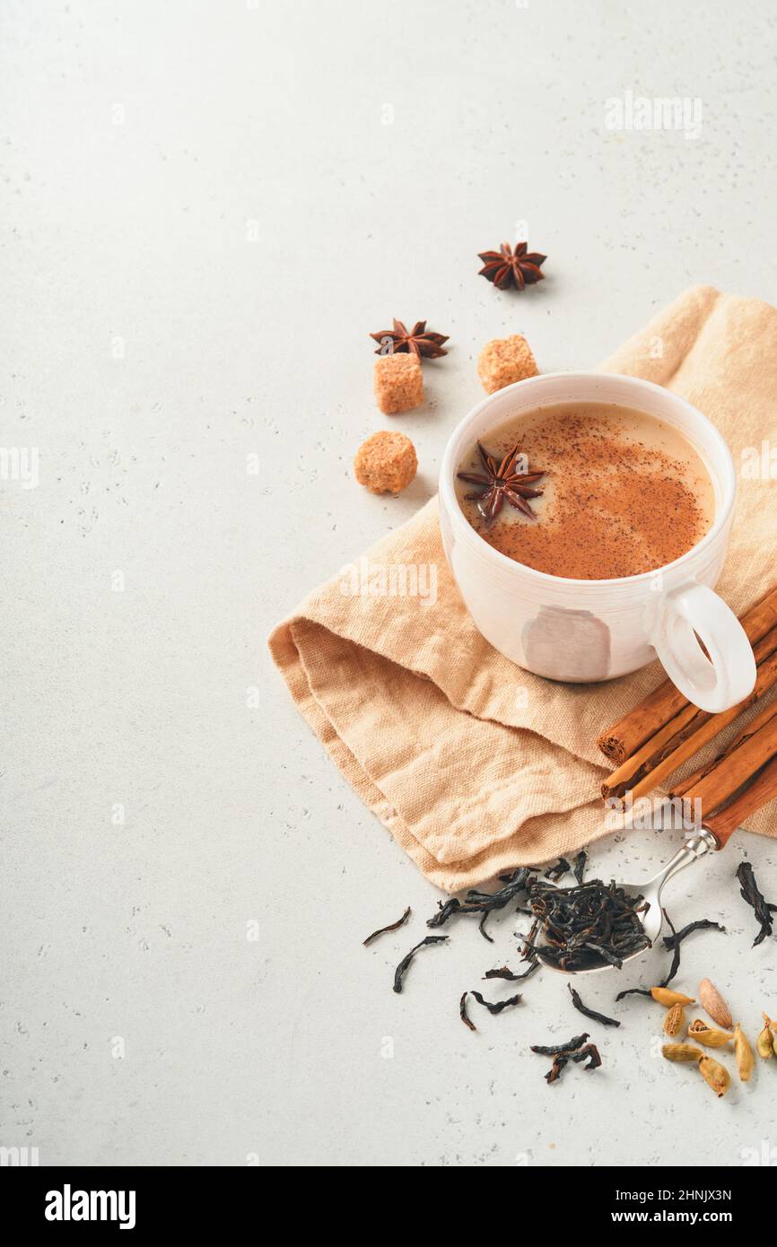 Masala tea. Masala chai spiced tea with milk and spices on light grey ...