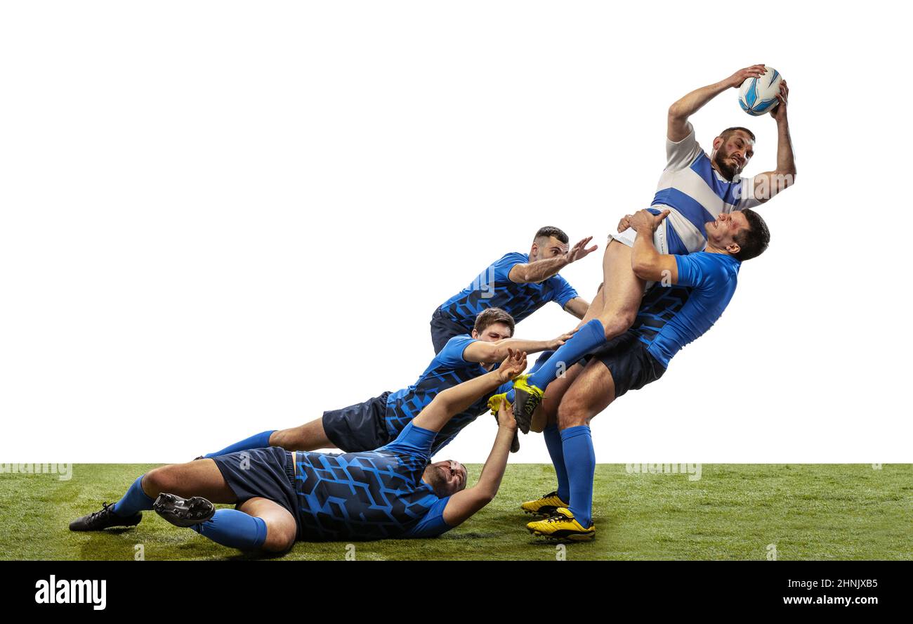 Muscled men, professional rugby players playing rugby football on grass ...