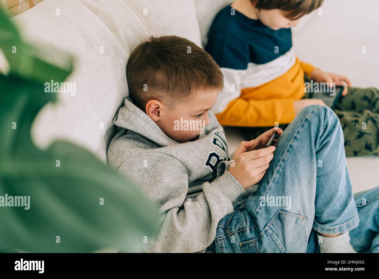 Cheerful two Childs boys playing online game, watching video on ...