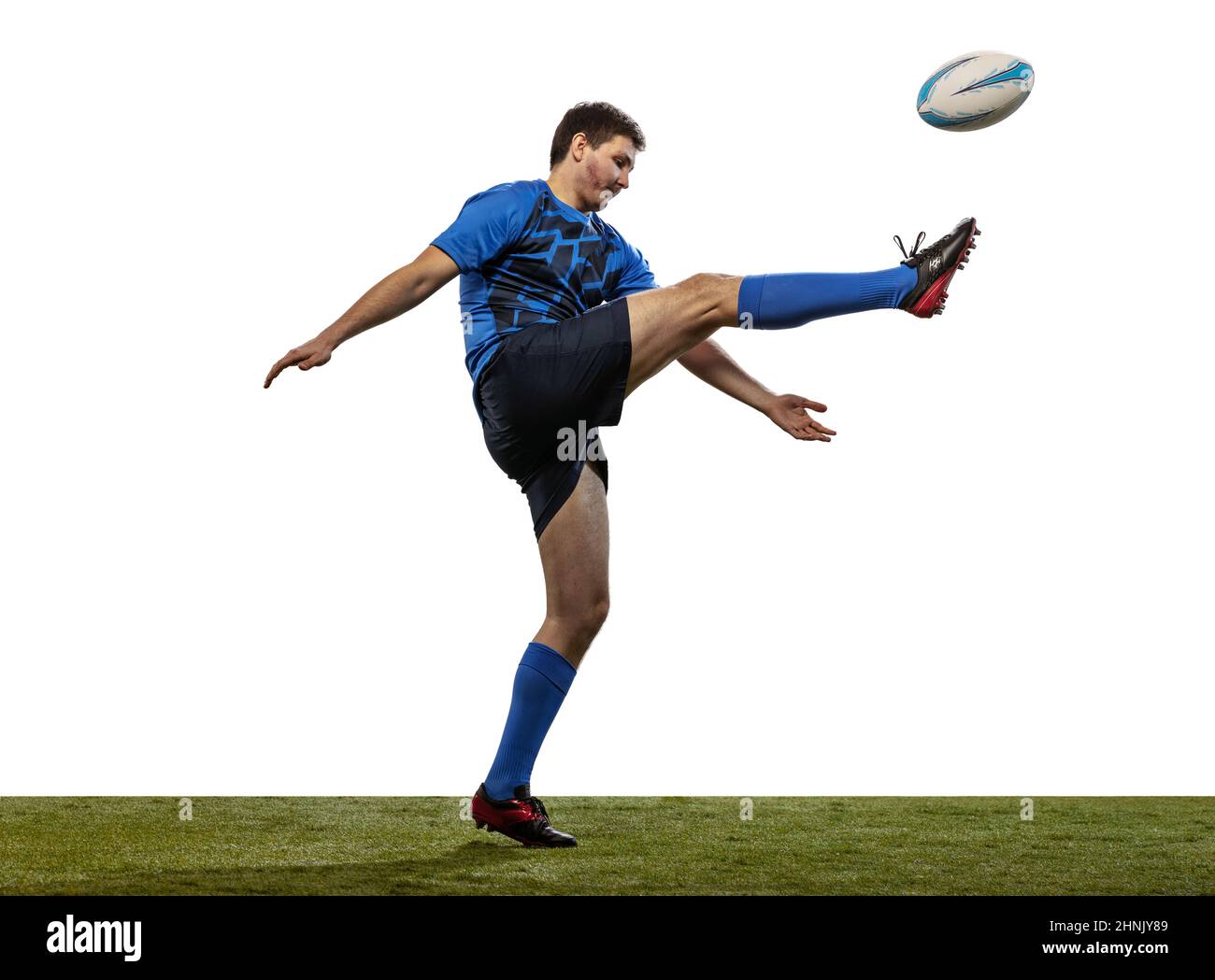 Professional rugby player wearinf blue sports uniform kicks ball ...