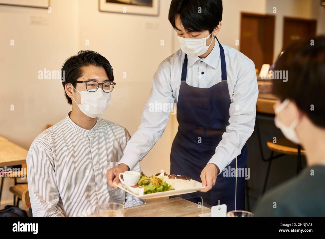 Japanese Male Waiter Serving Food Stock Photo - Alamy