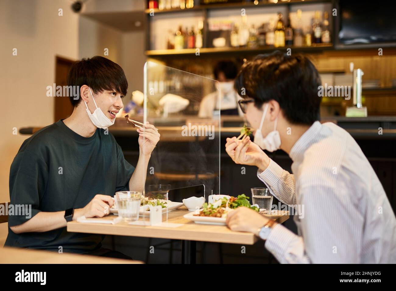 Two Japanese Men Having Dinner Over The Partition Stock Photo - Alamy