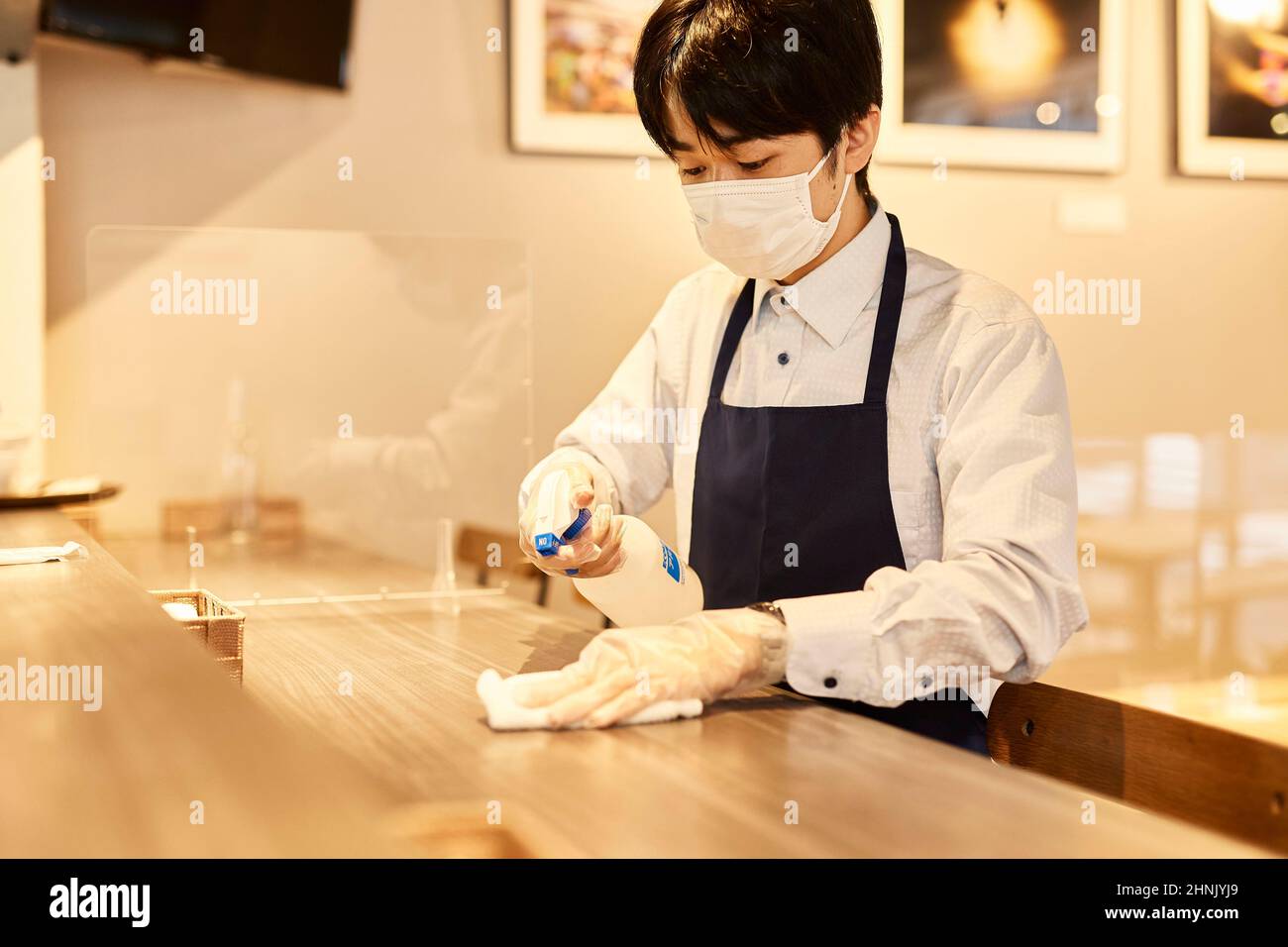 Japanese Male Waiter Sanitizing A Table With Alcohol Stock Photo - Alamy