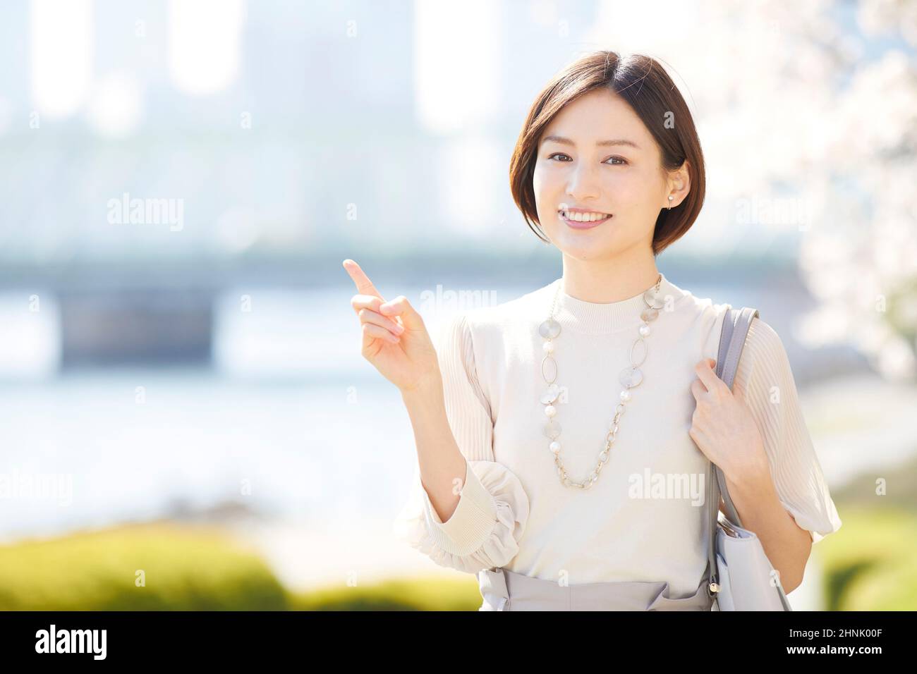 Young Japanese Woman Making Hand Sign Stock Photo - Alamy