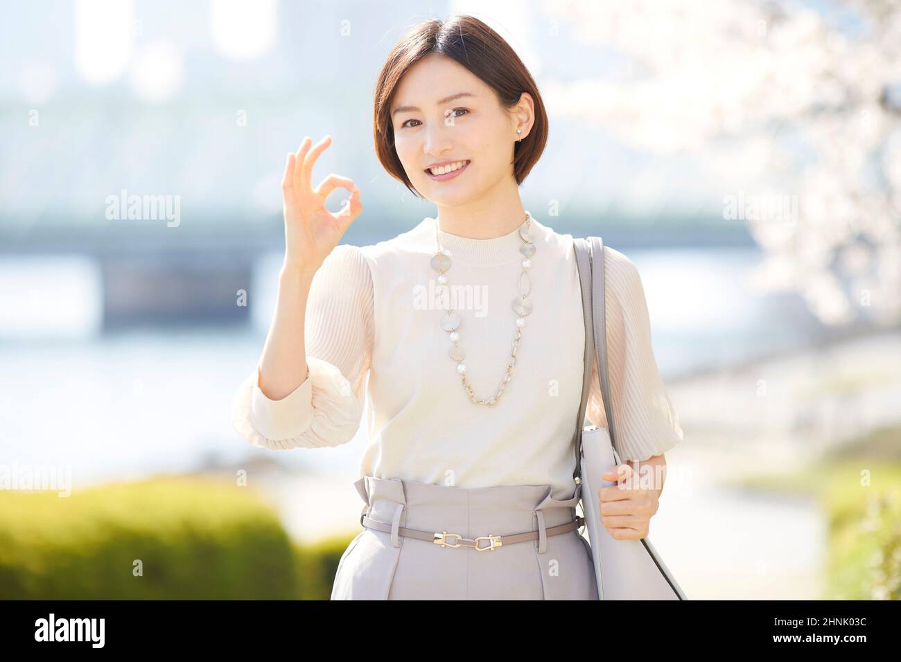 Young Japanese Woman Making Hand Sign Stock Photo - Alamy