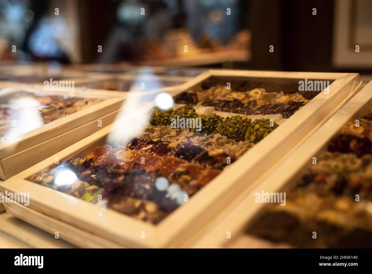 rows of Turkish delight sweets desserts in white cardboard packaging ...