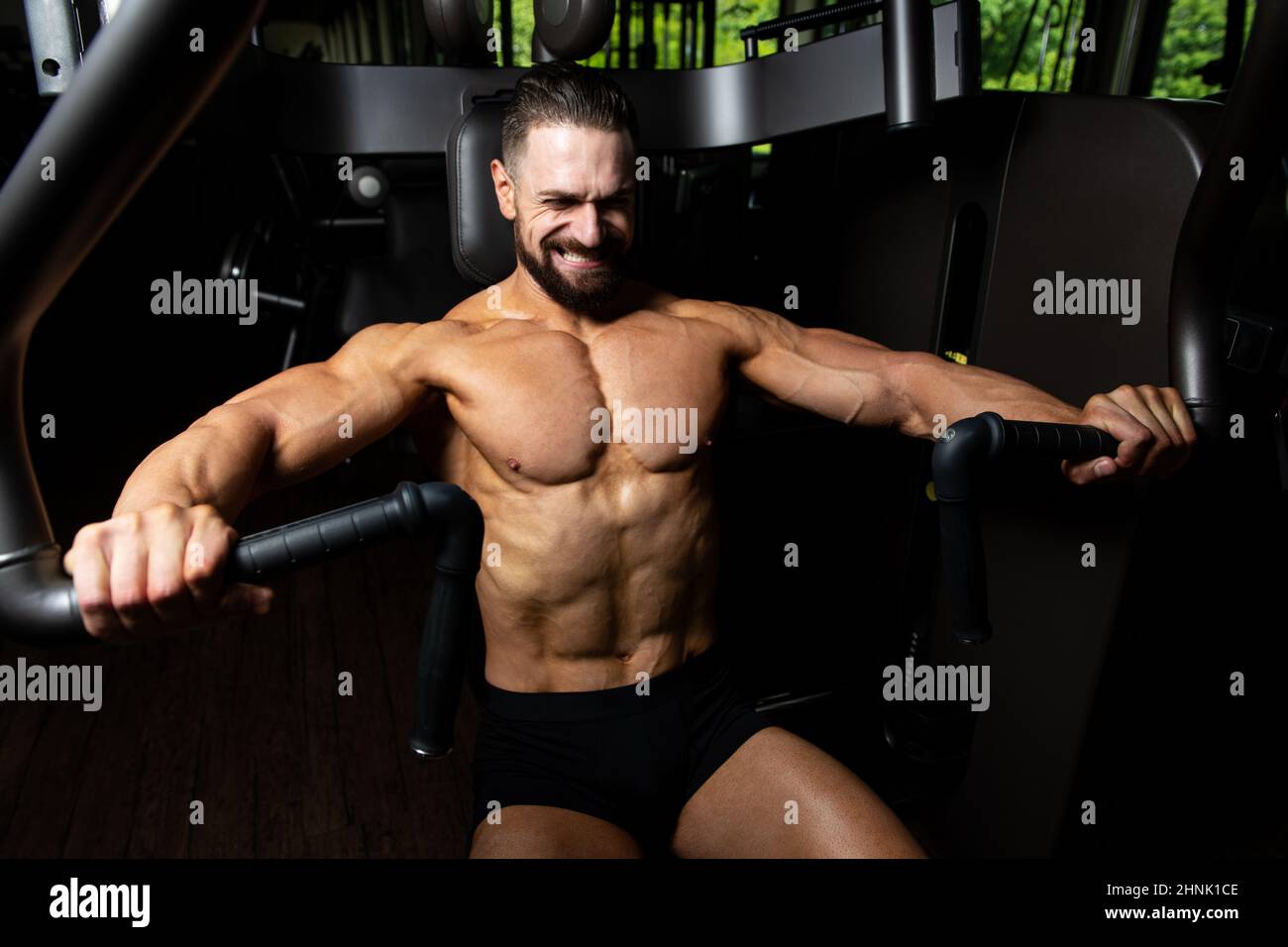 Bodybuilder Exercising Chest On Machine Stock Photo - Alamy