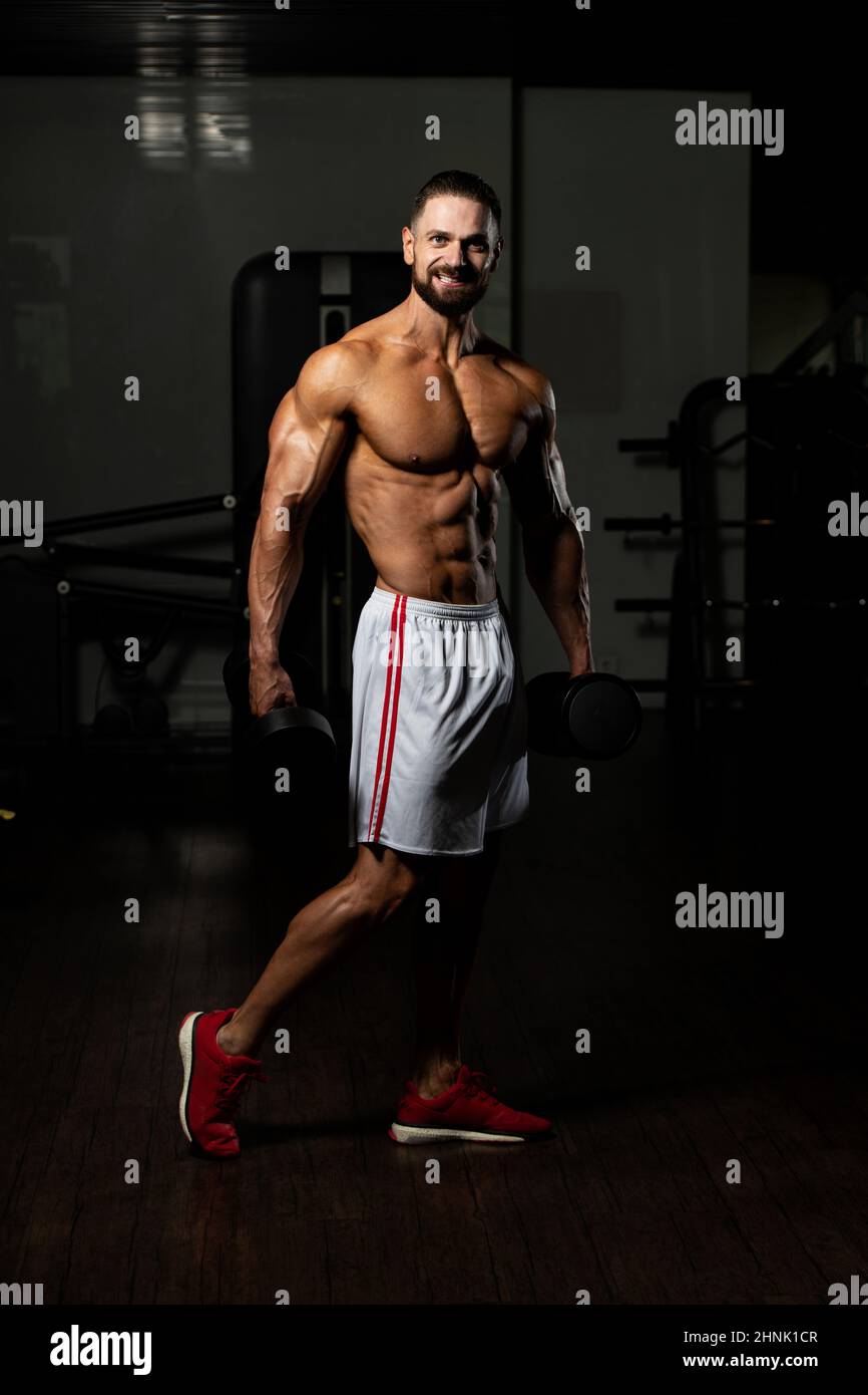 Bodybuilder Exercising Biceps With Dumbbells Stock Photo - Alamy