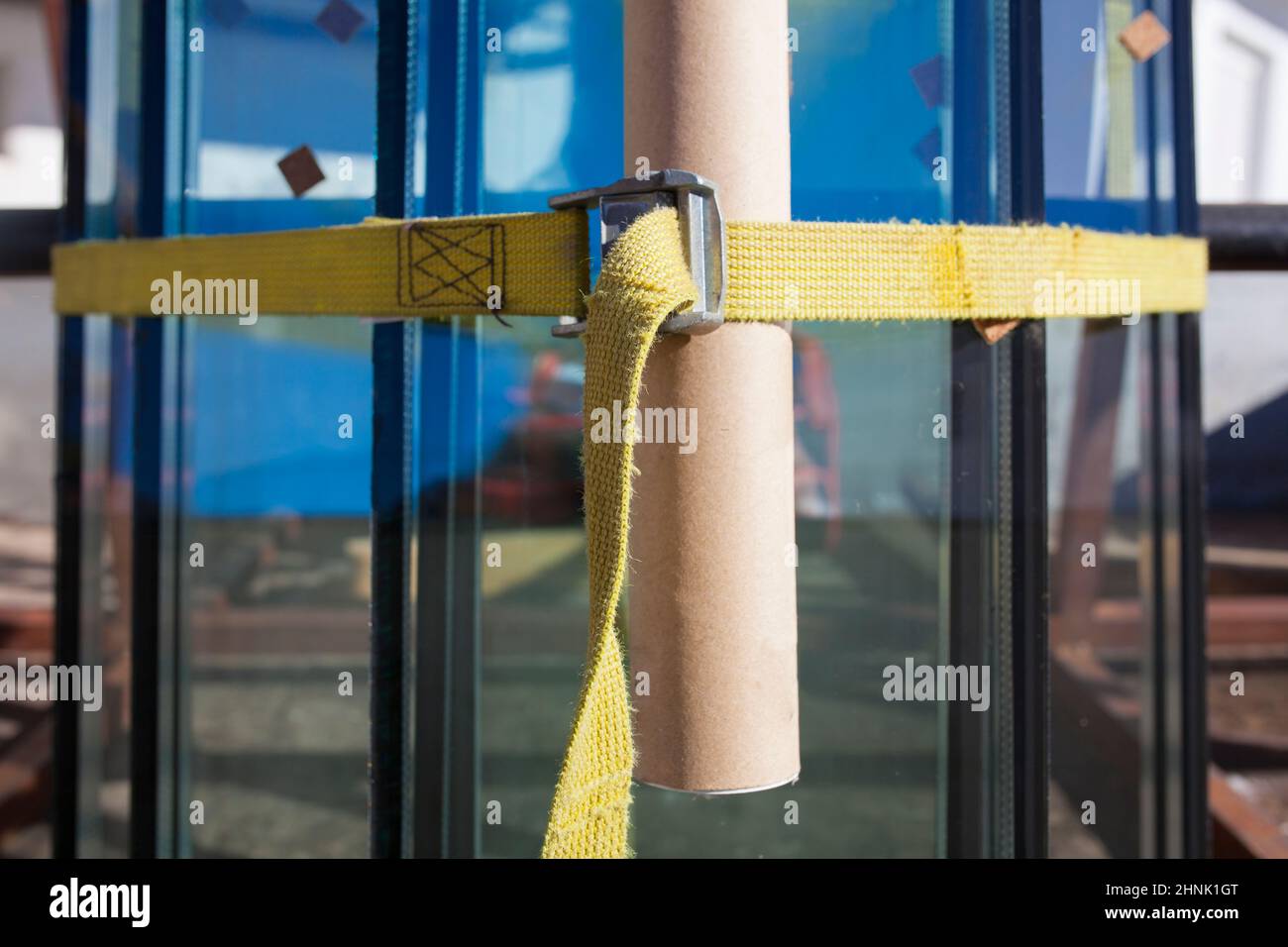 Some glass windows with straps and protected with cardboard tube ...