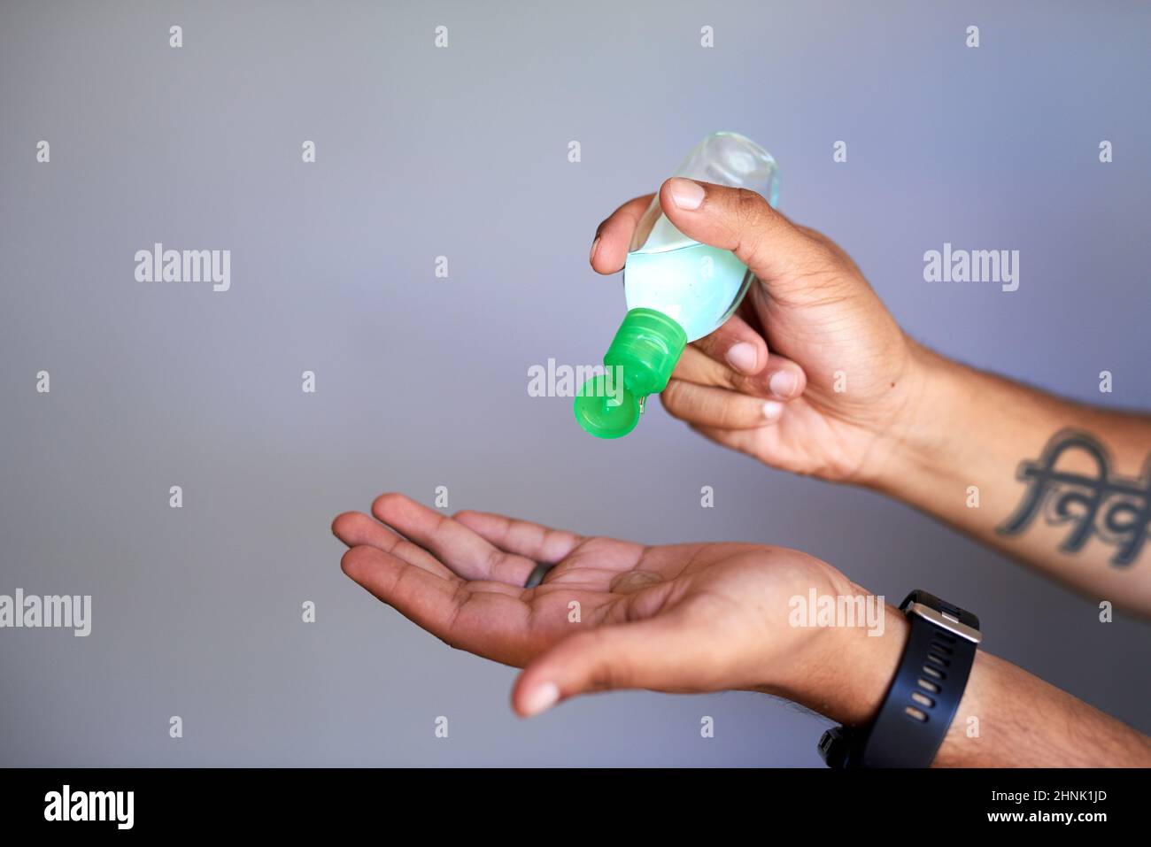 A close up shot of a man squeezing hand sanitiser into his palm Stock ...