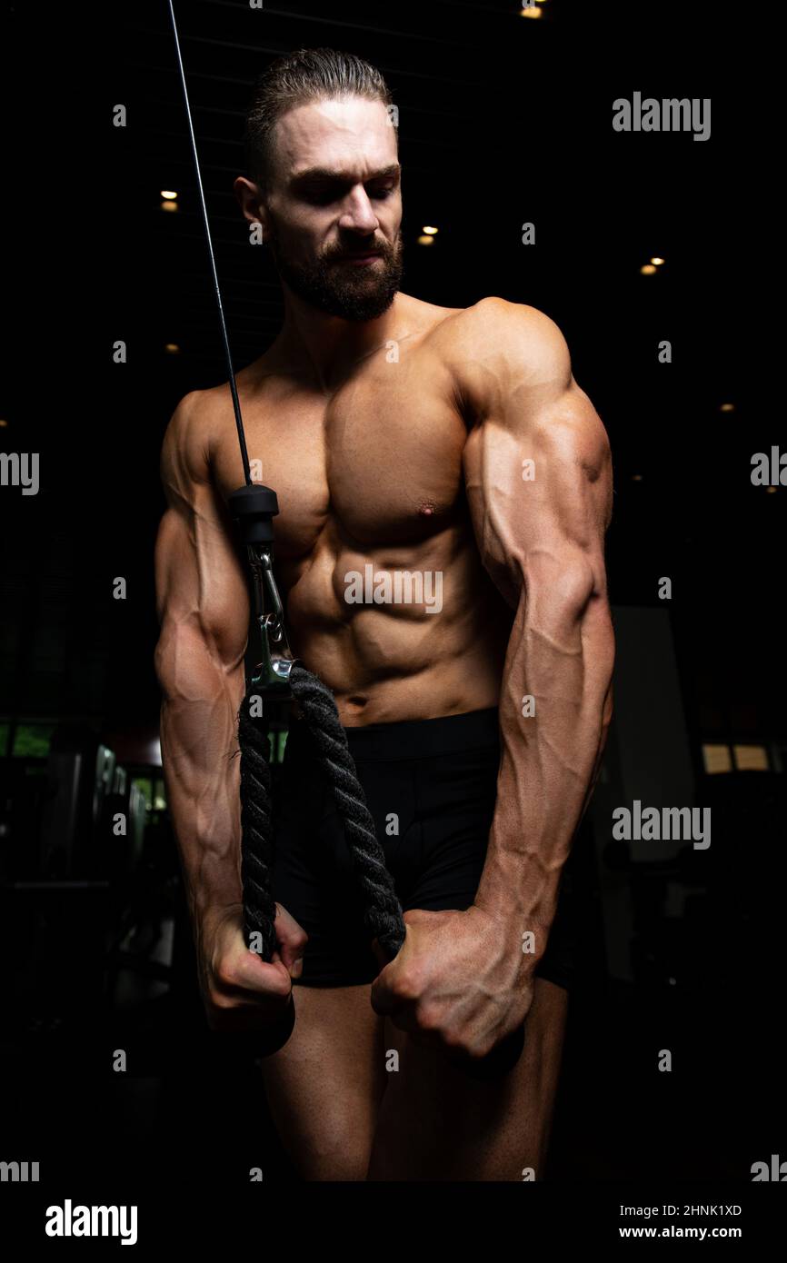 Bodybuilder Doing Heavy Exercise For Triceps With Cable Stock Photo - Alamy
